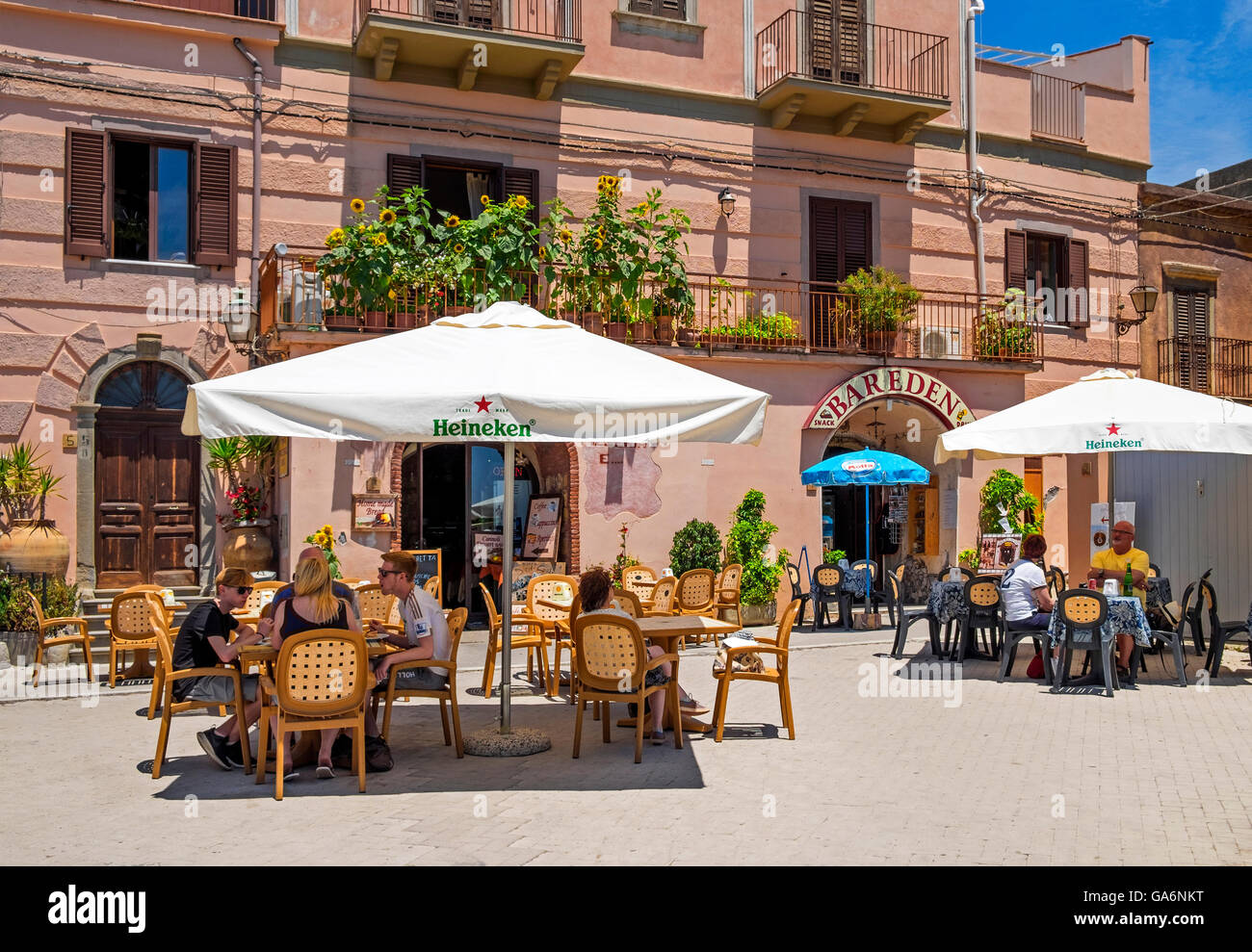 Visitors taking shade and refreshments in the village square of Forza D ...