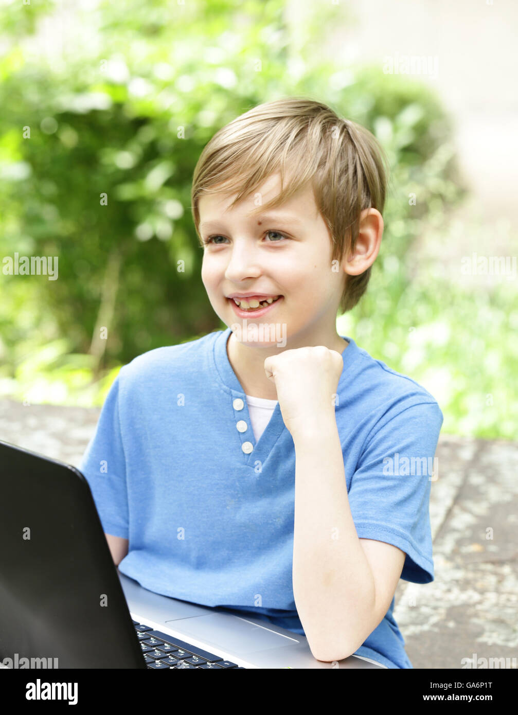 boy playing on the computer (laptop) in a park Stock Photo - Alamy