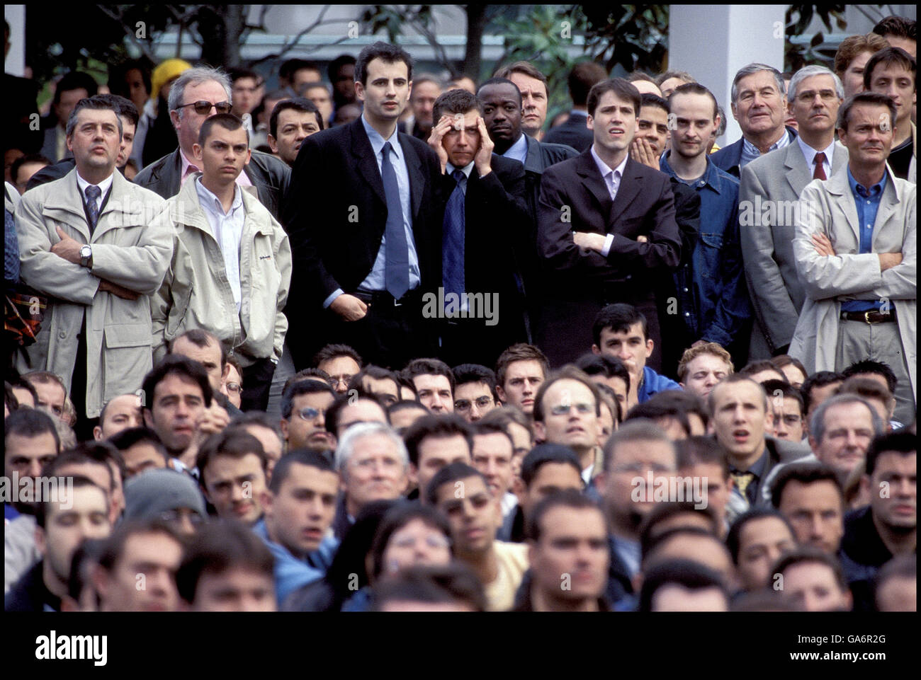 People watch France play in a 2002 soccer World Cup game shown on a ...
