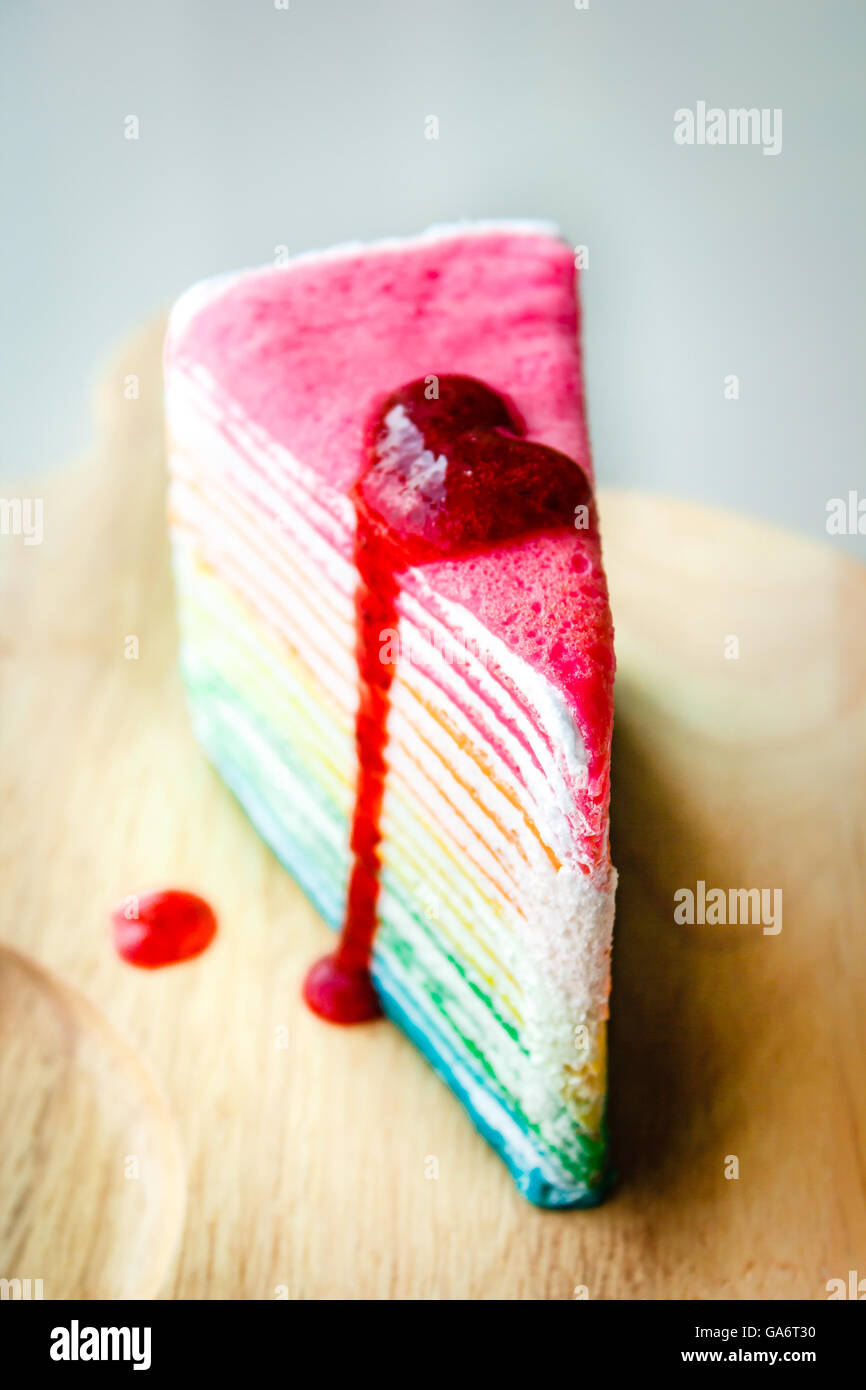 Rainbow crape cake with strawberry sauce Stock Photo - Alamy