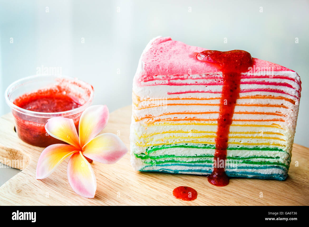 Rainbow crape cake with strawberry sauce Stock Photo - Alamy