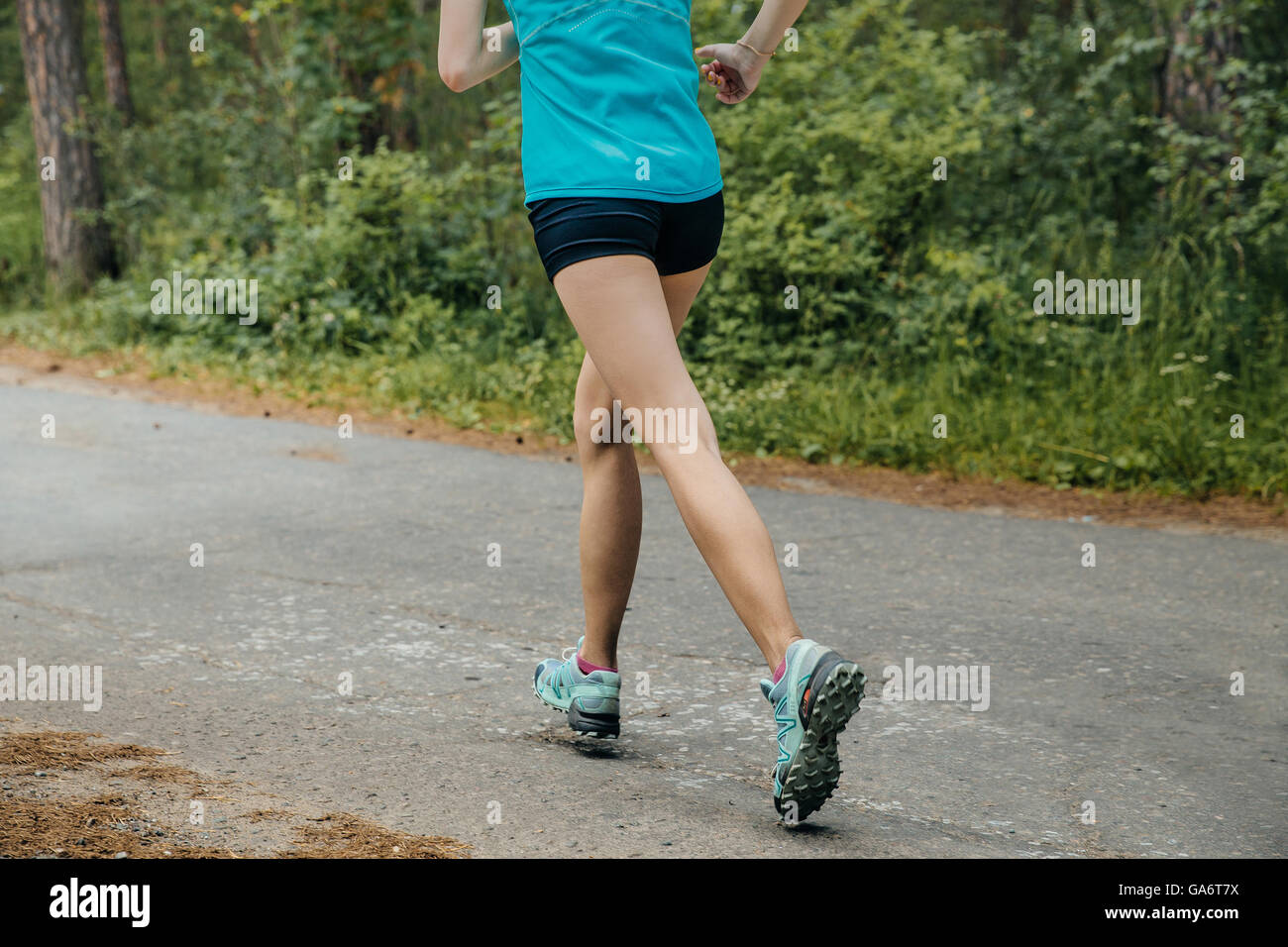 feet girl running down road in woods during a marathon Stock Photo - Alamy