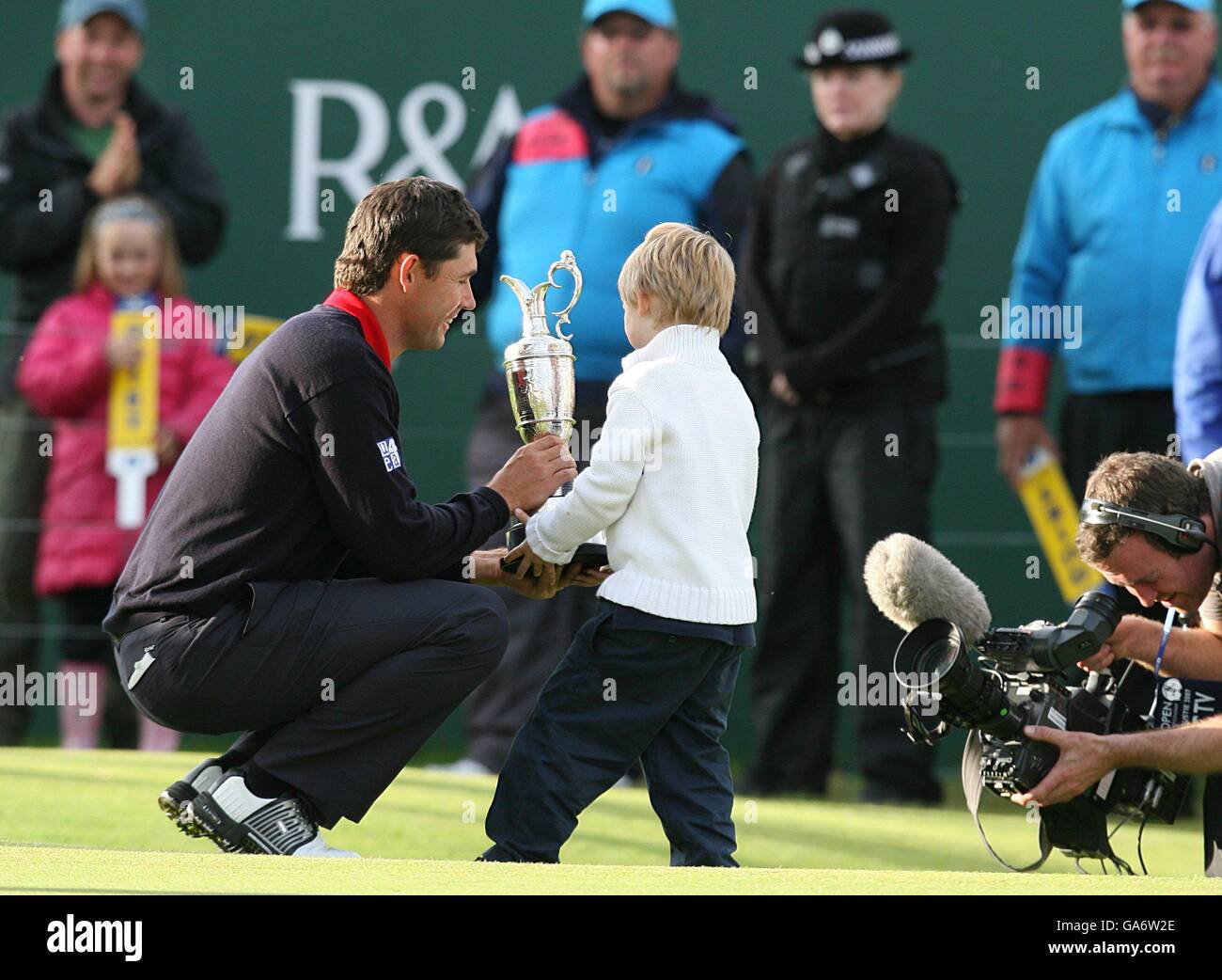 Ireland's Padraig Harrington hands the Claret Jug to his son Patrick ...