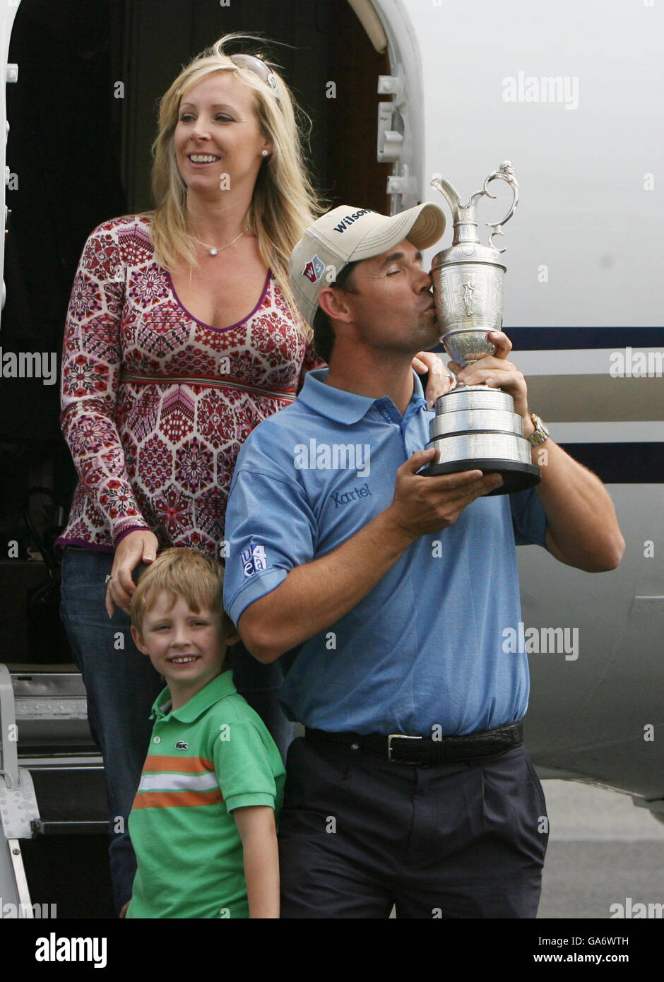 Ireland's Padraig Harrington kisses the Claret Jug alongside his wife ...