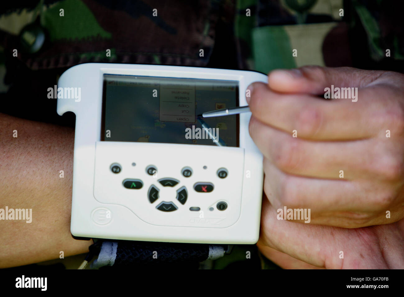 Lance Corporal Andrew Reed demonstrates a wrist-bound palm top computer ...