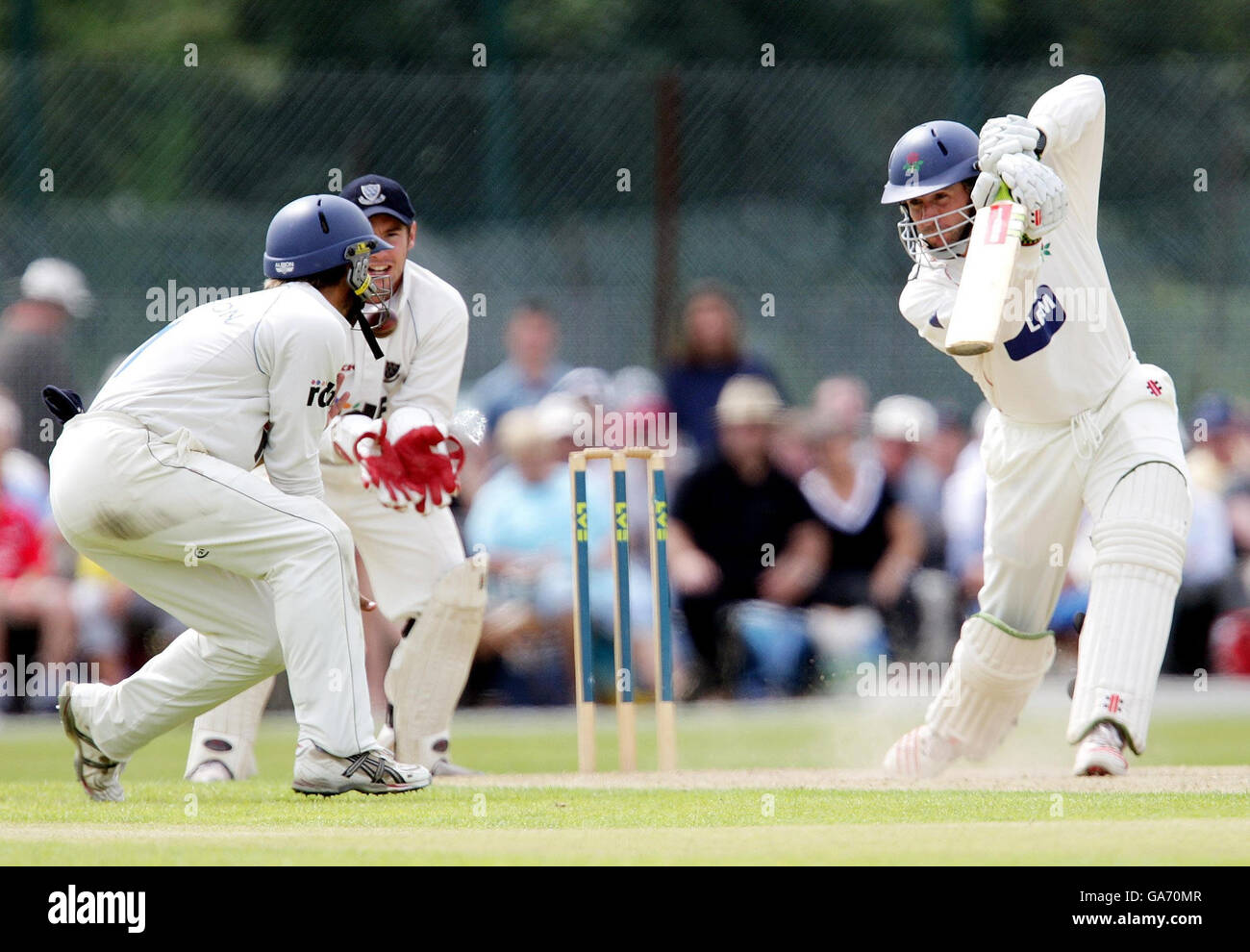 Lancashire's Luke Sutton (right) hits the ball against Sussex's Carl ...