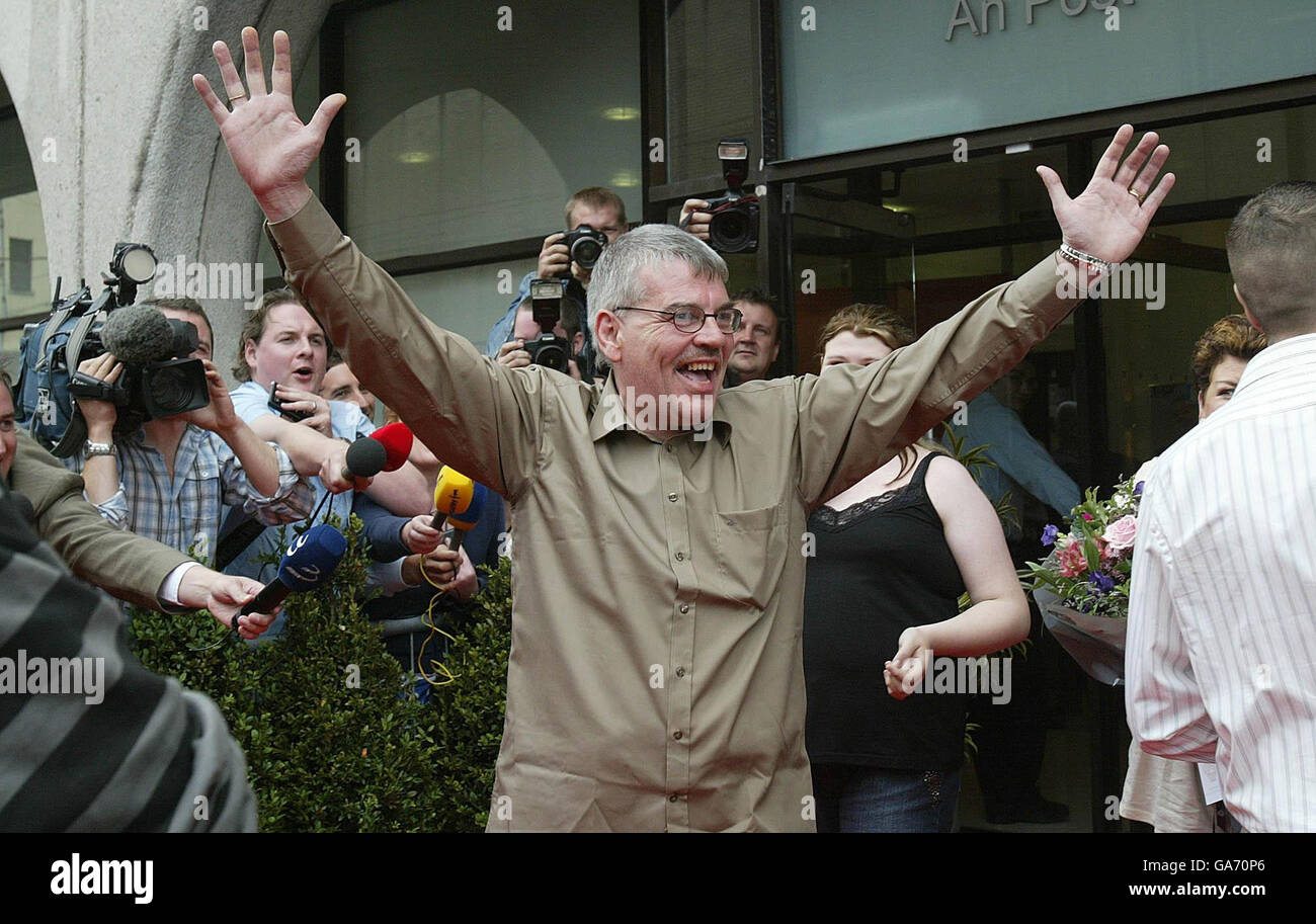 Ireland's latest lottery millionaire Paul Cunningham waves to the media ...