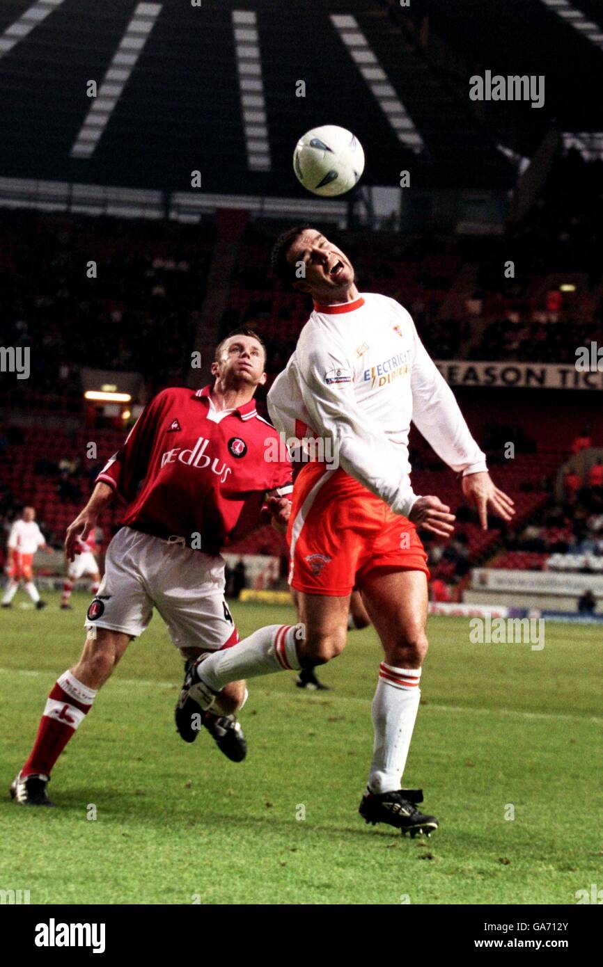 Blackpool's Brian Reid clears the ball under pressure from Charlton ...