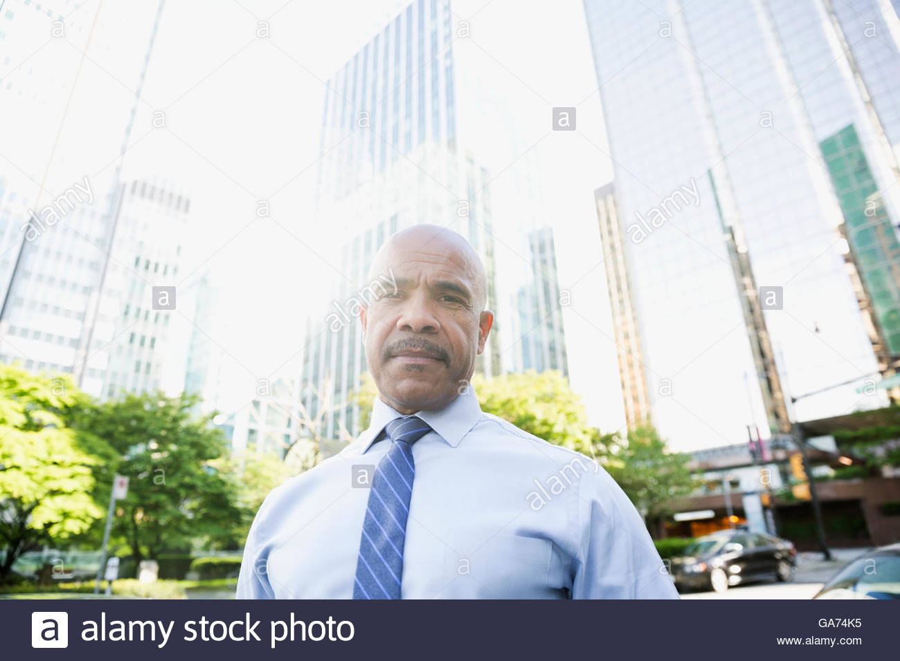 Businessman standing below highrise buildings hi-res stock photography ...