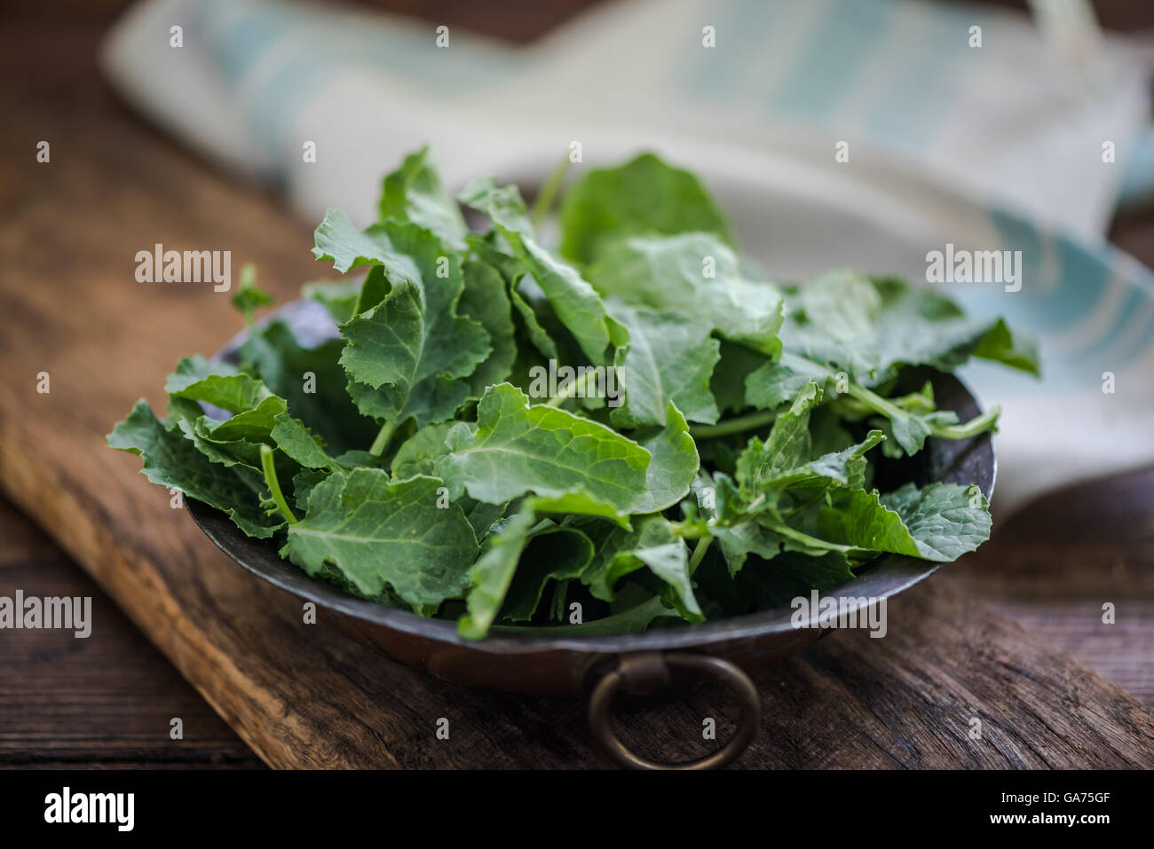 baby kale leaves in rustic bowl Stock Photo - Alamy
