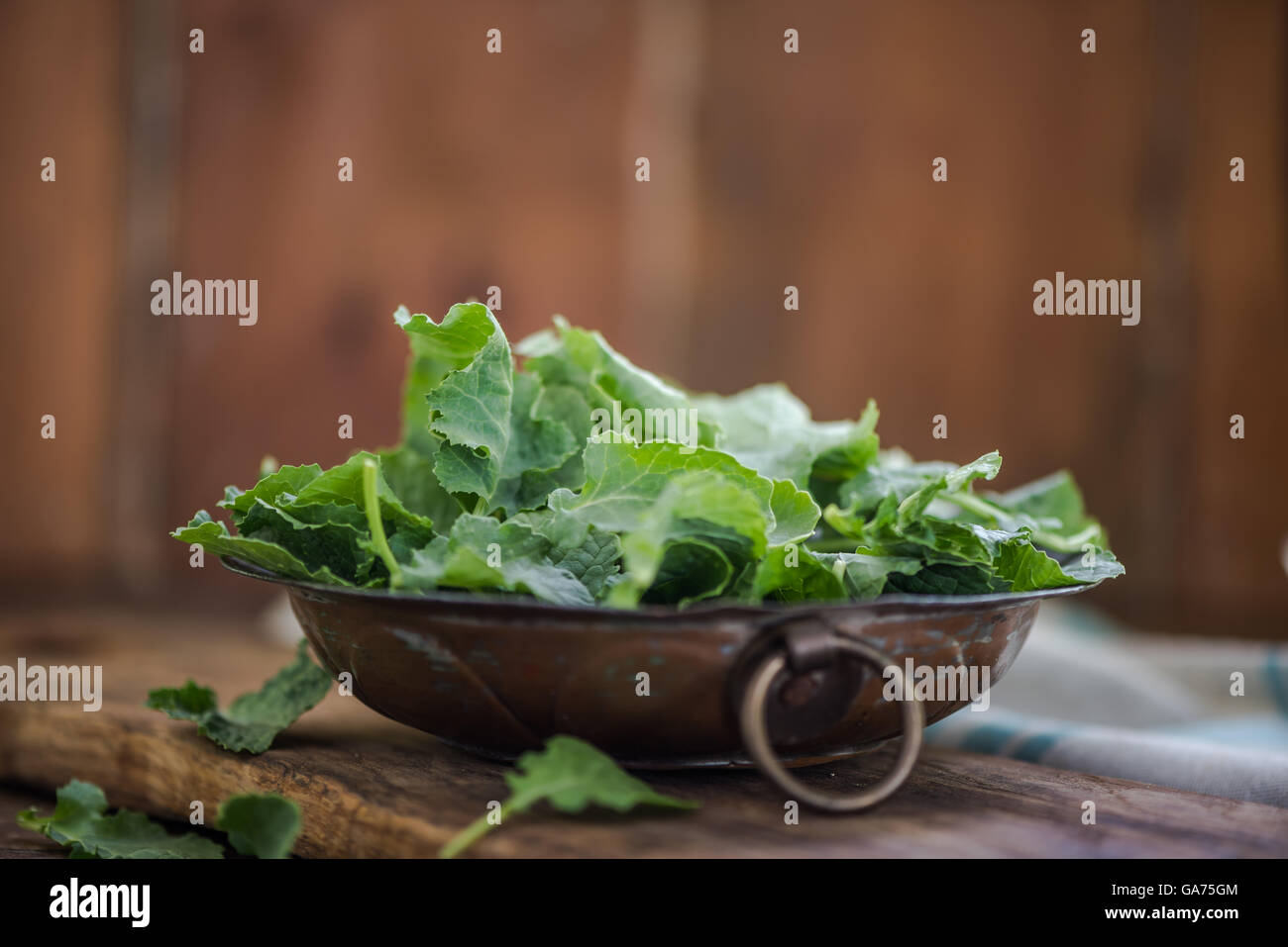 baby kale leaves in rustic bowl Stock Photo - Alamy