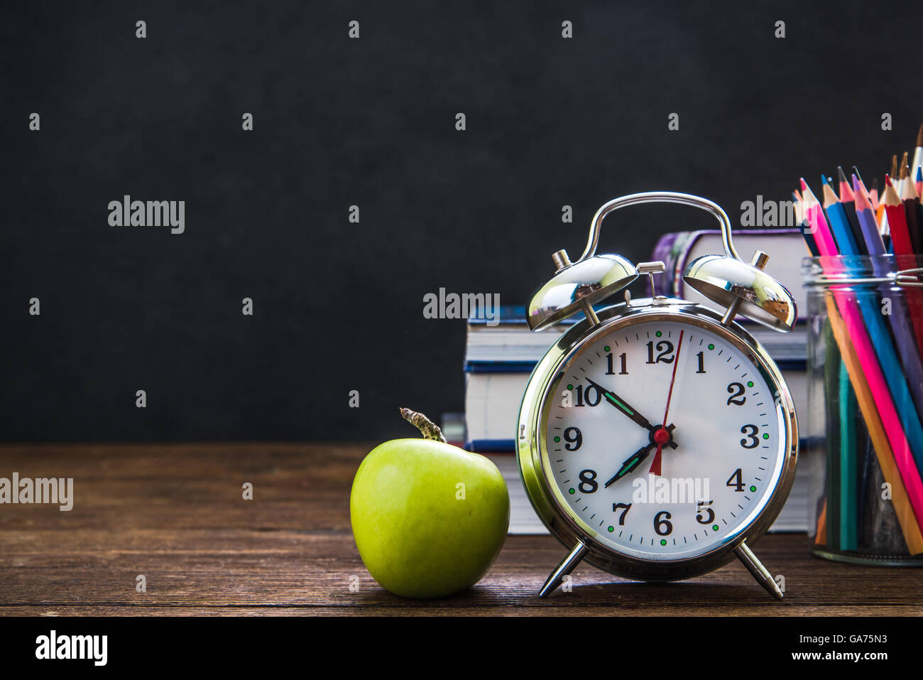 retro alarm clock and classroom chalkboard, back to school concept ...