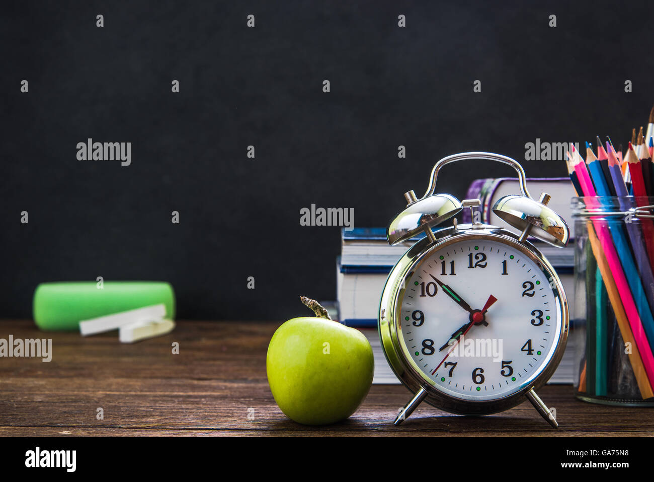 retro alarm clock and classroom chalkboard, back to school concept ...