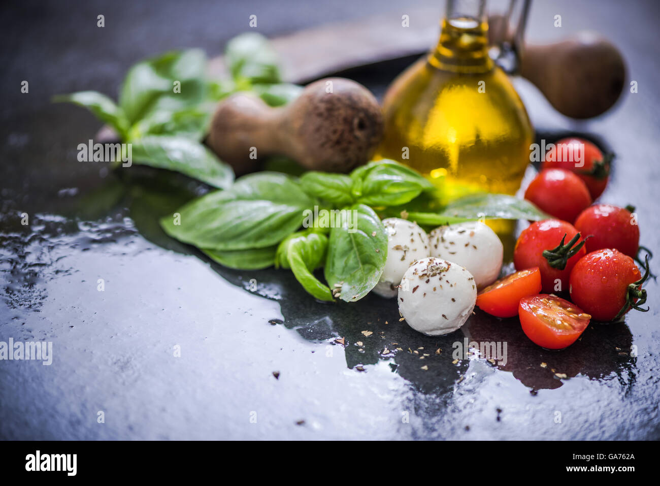 fresh italian food ingredients on dark slate Stock Photo - Alamy