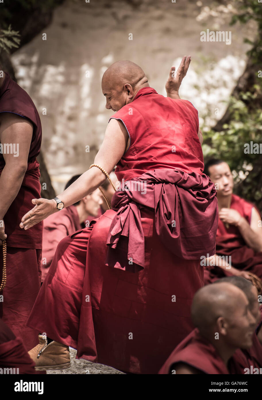 A senior monk challenges his fellow monks to debate Stock Photo - Alamy