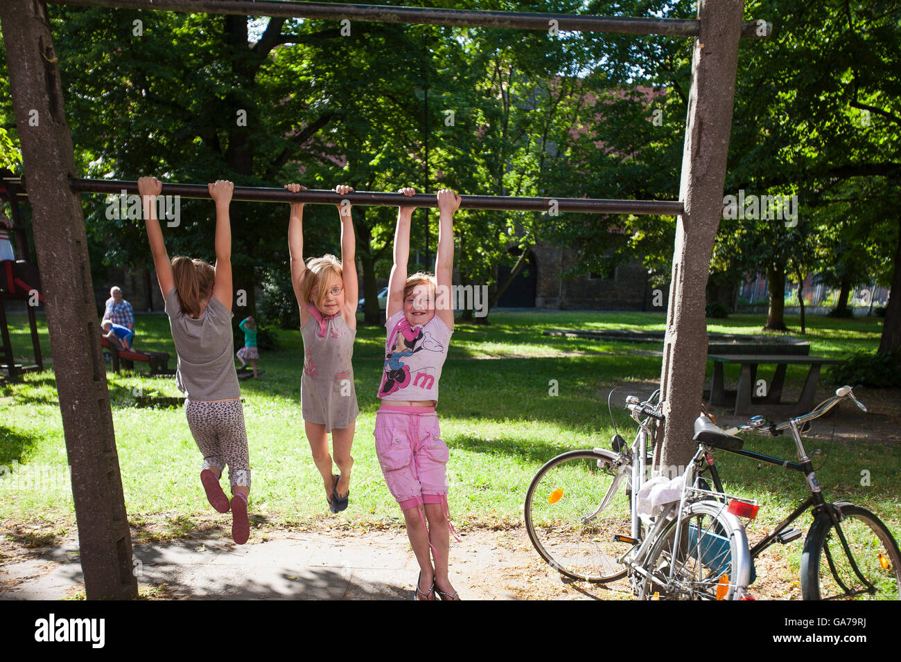 Three children play in a public playground in a neighbourhood of the ...