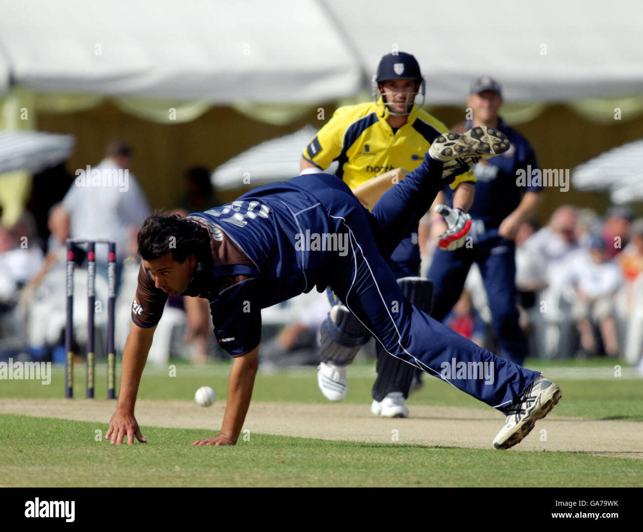 Surrey Brown Caps' Jimmy Ormond can't stop the ball running away Stock ...