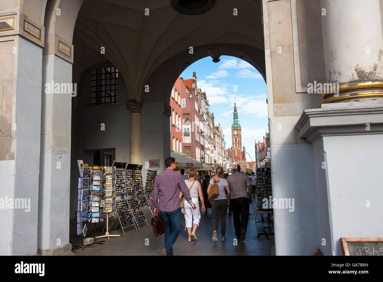 Summer crowds pass through the famous Golden gate of Gdansk at the end ...