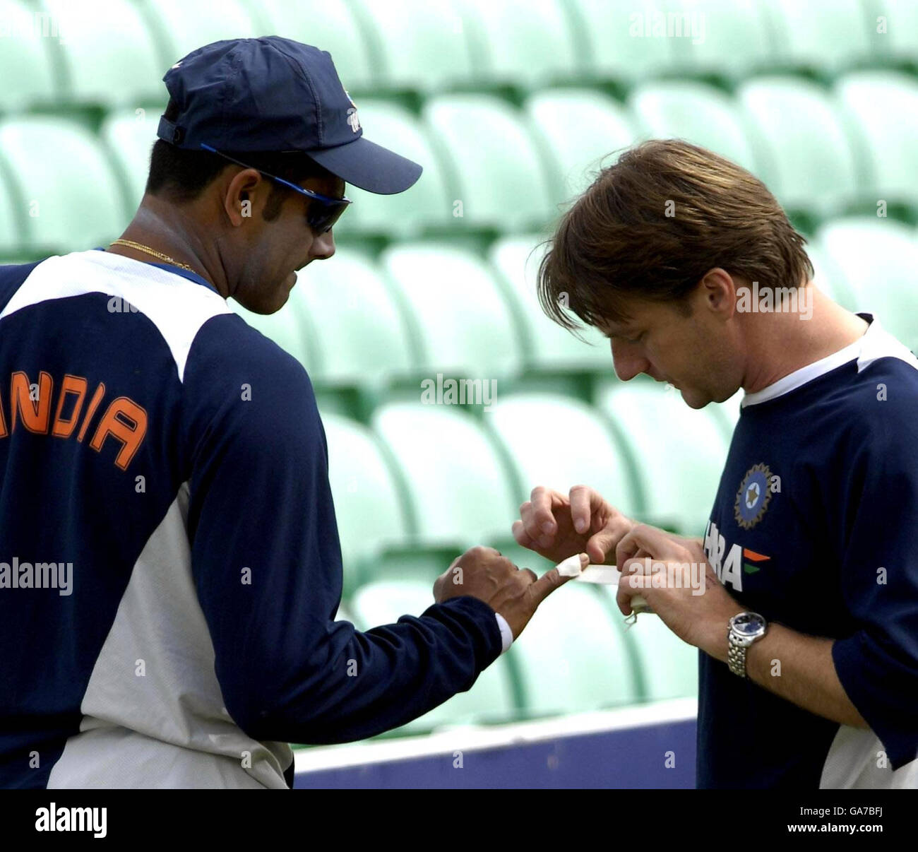 India's spin bowler Anil Kumble (left) receives some attention to his ...