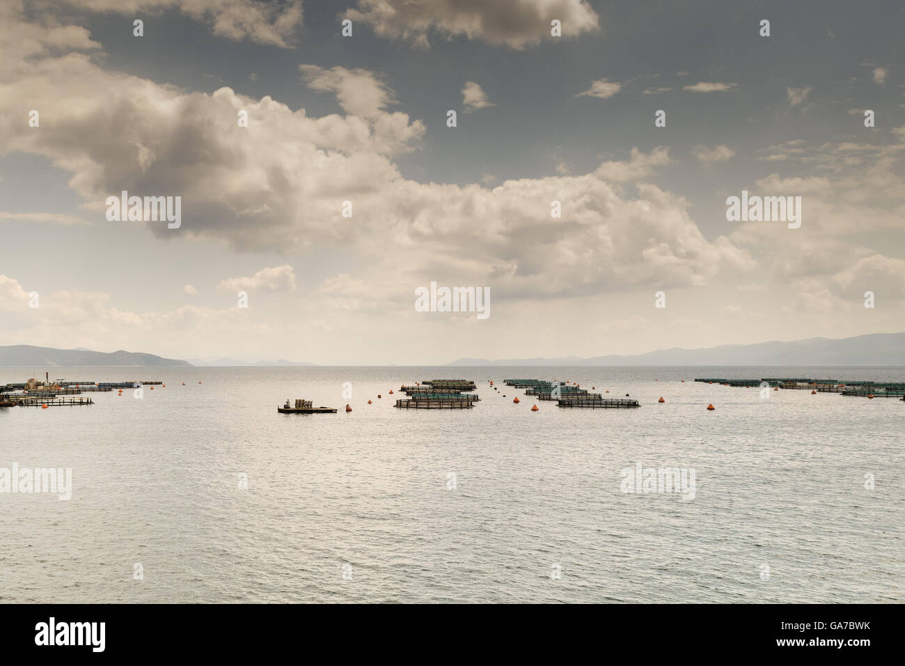 Fish farming against a dramatic sky Stock Photo - Alamy
