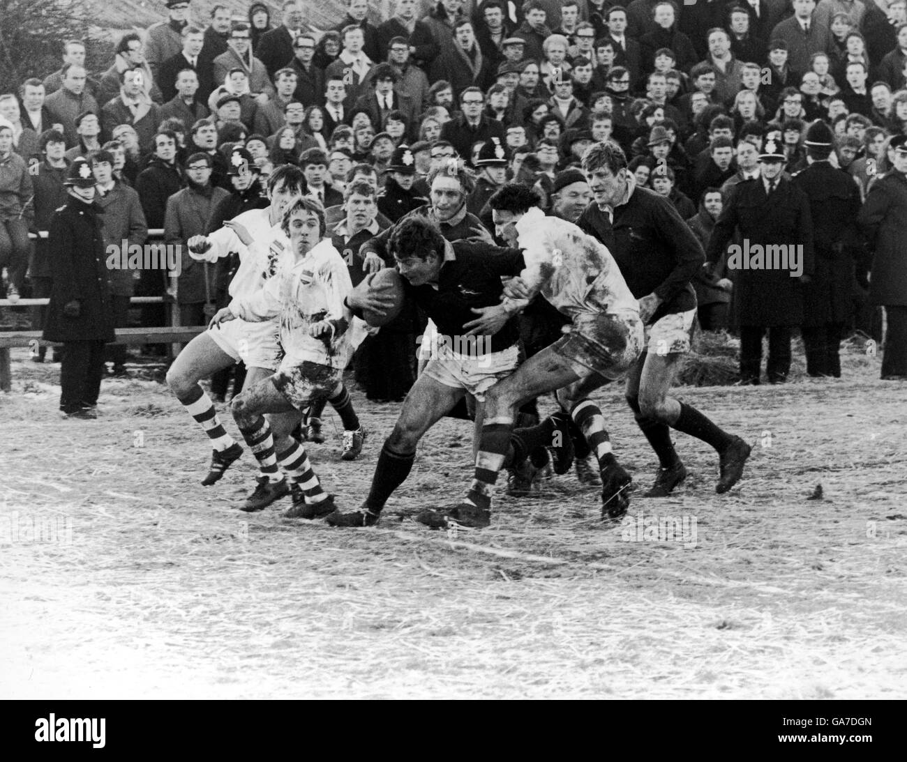 South Africa's Jan Ellis (c) holds off Midlands Counties West's ...