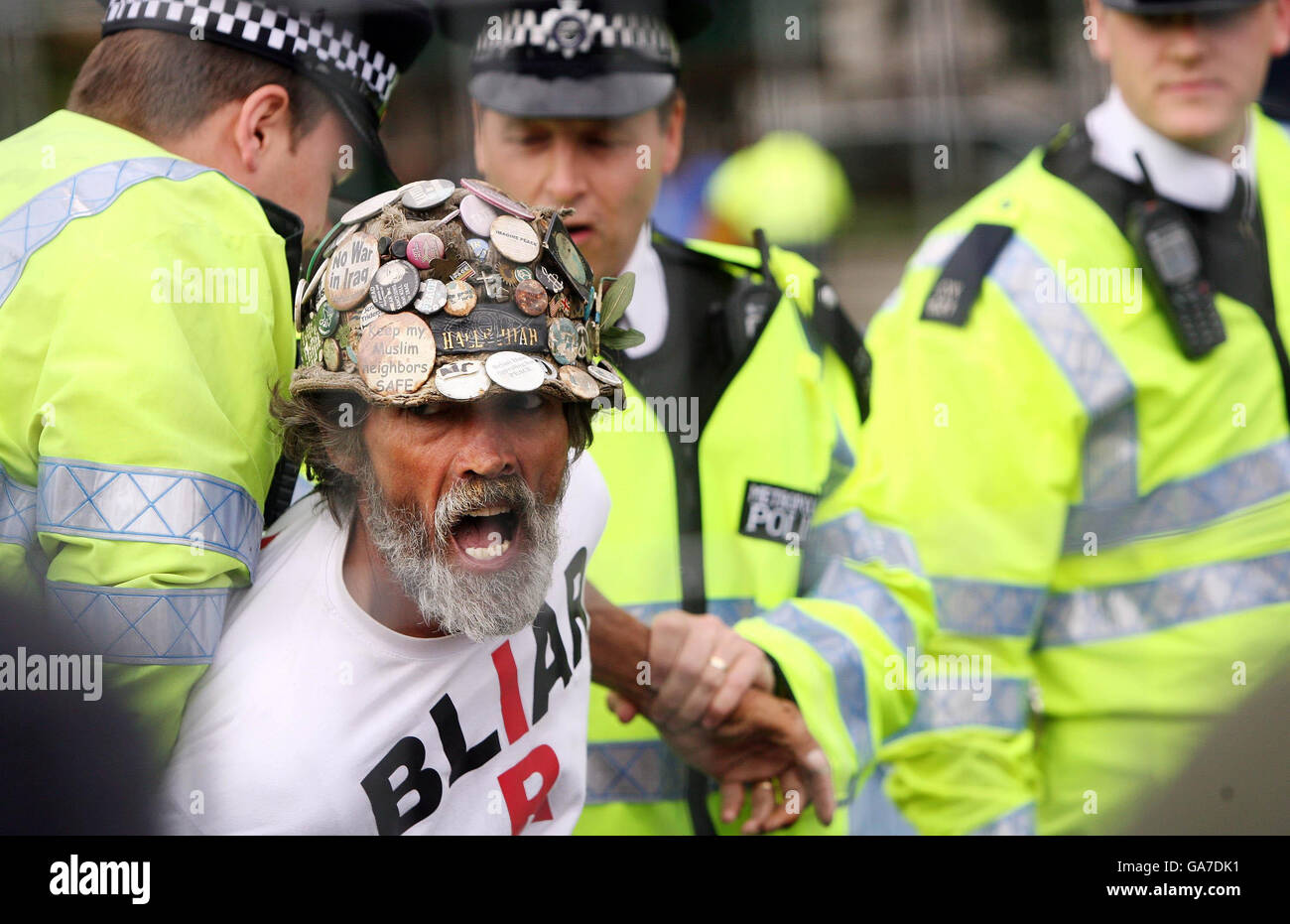 Peace campaigner Brian Haw with police after letters were issued to ...