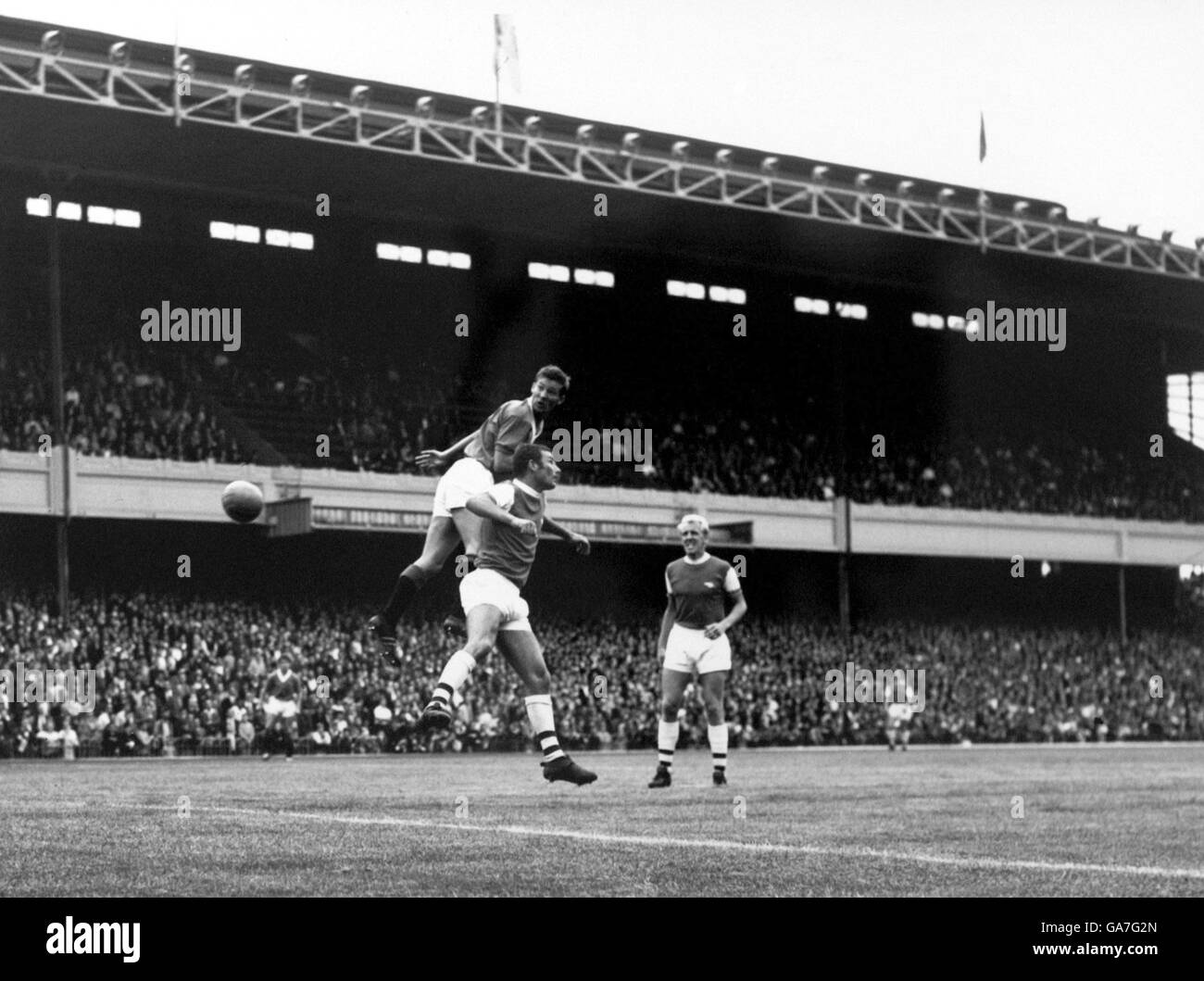 (L-R) Rangers' Alex Ferguson leaps higher than Arsenal's Terry Neill to ...