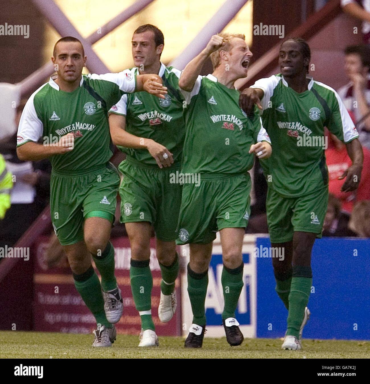 Hibernian's Brian Kerr (centre right) celebrates after scoring against ...