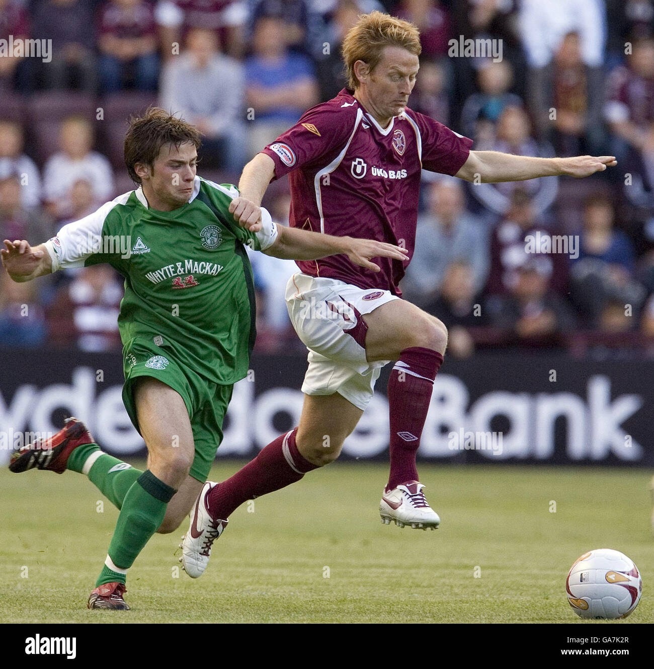 Hibernian's Lewis Stevenson challenges Hearts' Michael Stewart during ...