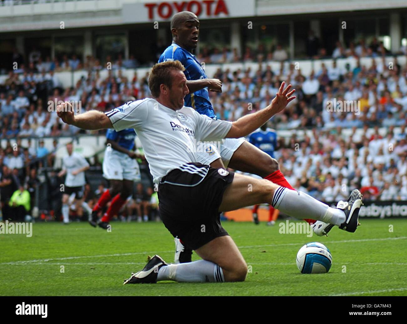 Derby County's Steve Howard tries to croos the ball under pressure from ...