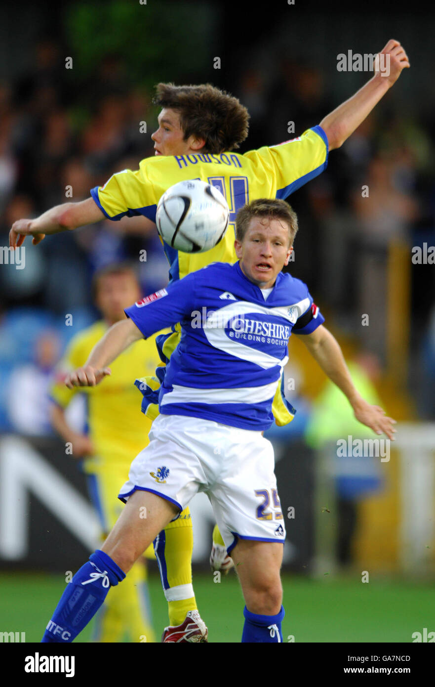 Macclesfield Town's Terry Dunfield jumps with Leeds United's Jonathon ...