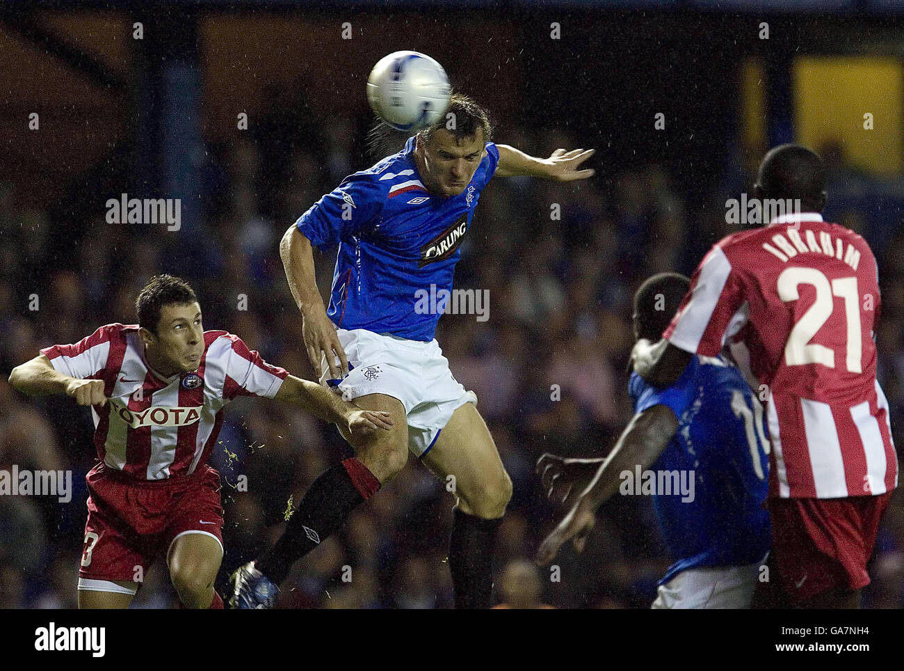 Rangers' Lee McCulloch (centre) rises above the Crvena Zvezda defence ...