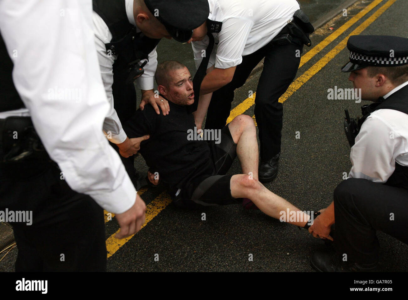 A man is restrained by police close to the "Camp for Climate Action ...