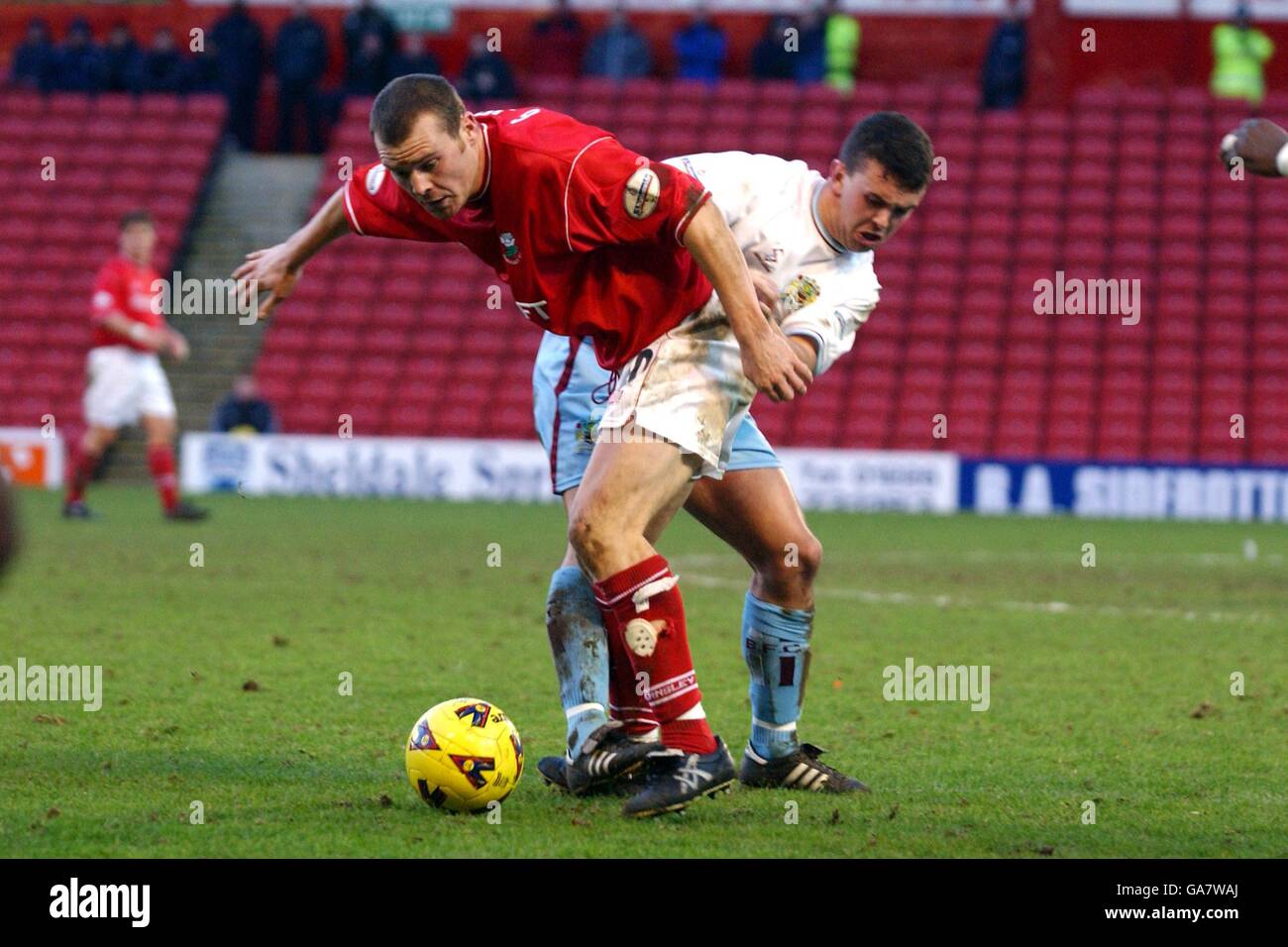 Barnsley's Mitch Ward holds off Burnley's Paul Weller Stock Photo - Alamy