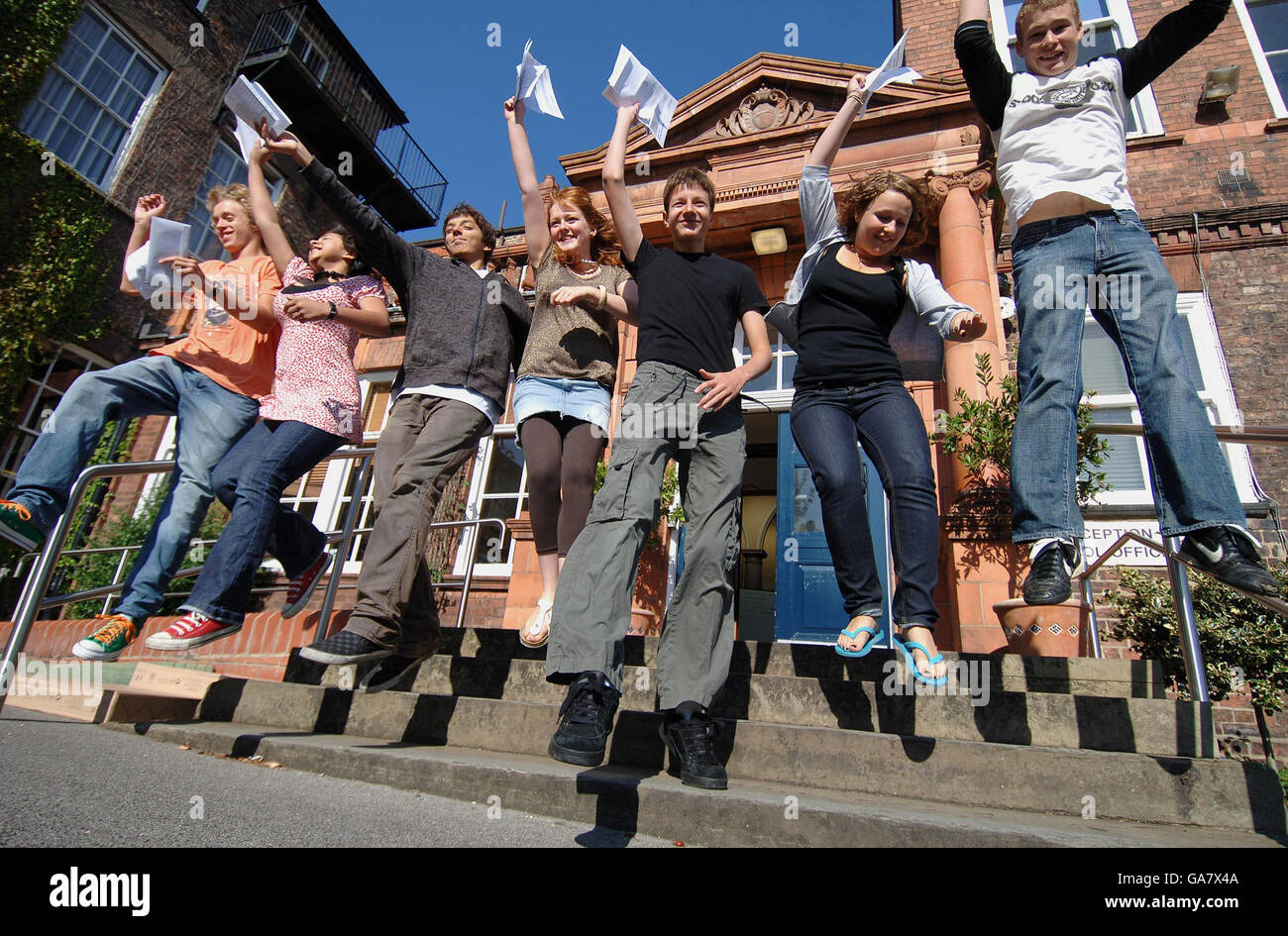A group of pupils, who all obtained over 10 A/A* grades, celebrate ...