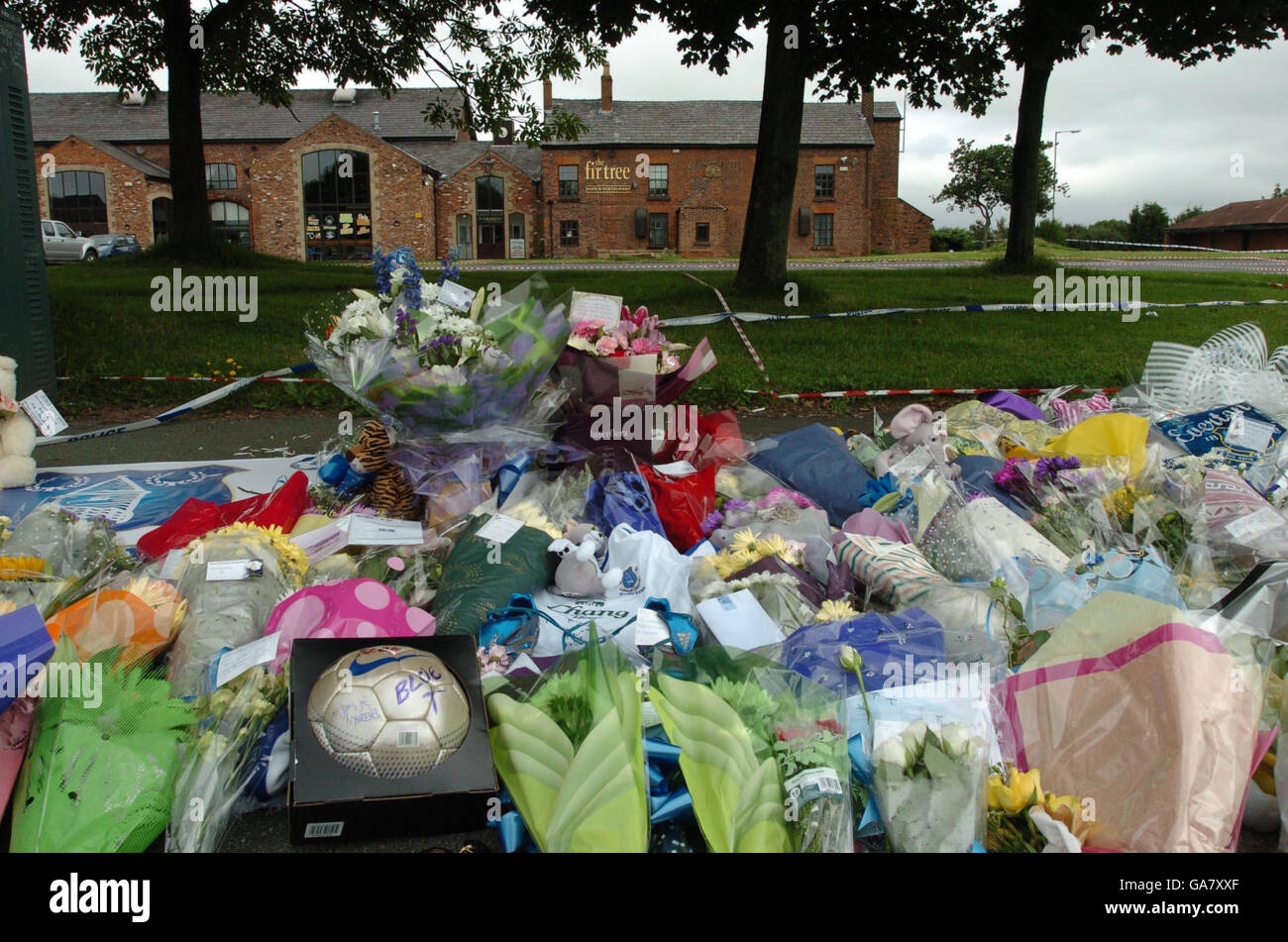 Flowers laid outside the Fir Tree pub, Croxteth Park, in memory of ...