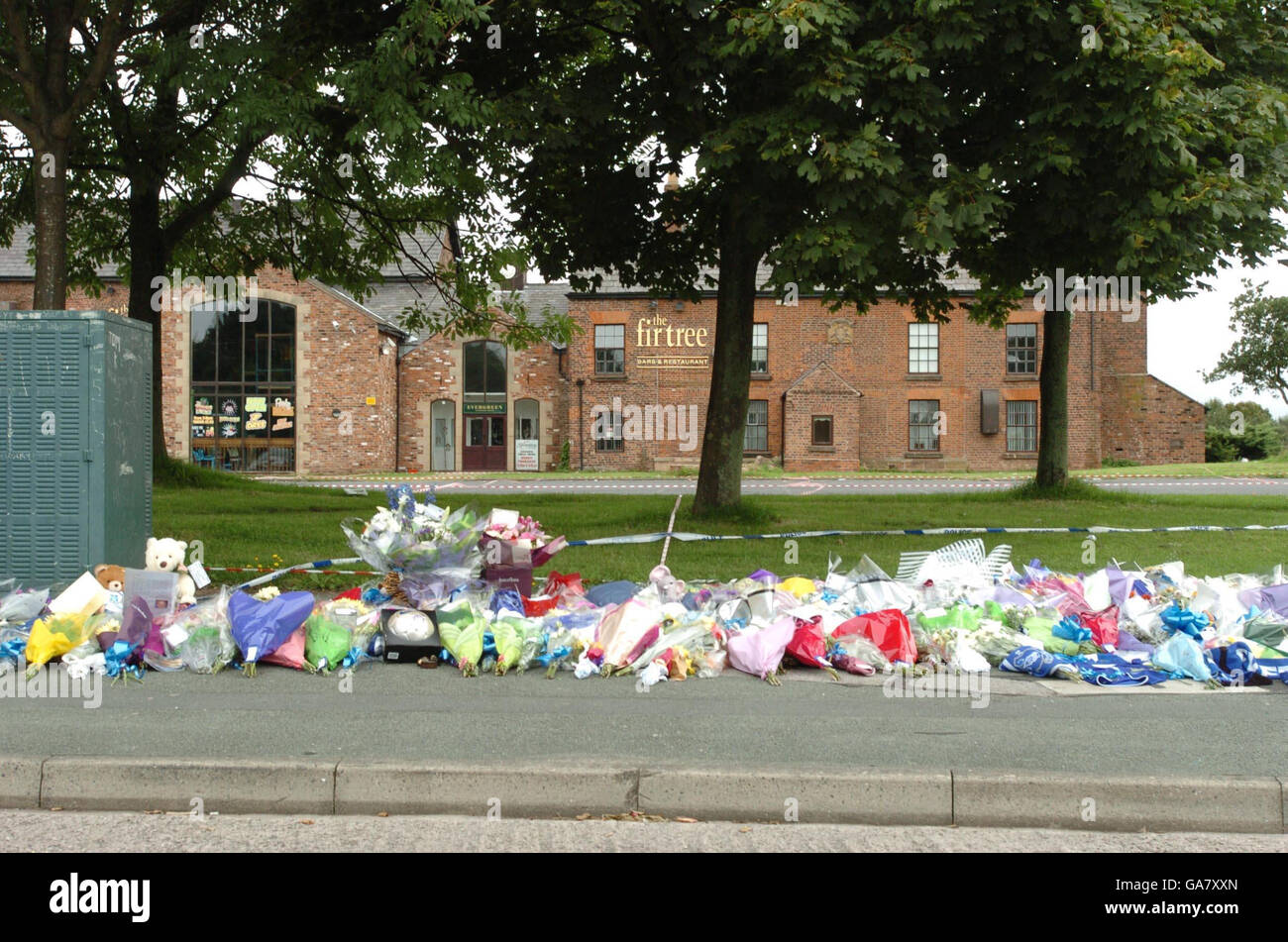 Flowers laid outside the Fir Tree pub, Croxteth Park, in memory of ...