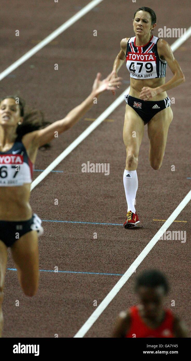 Athletics world full length action runners running winning arm raised ...