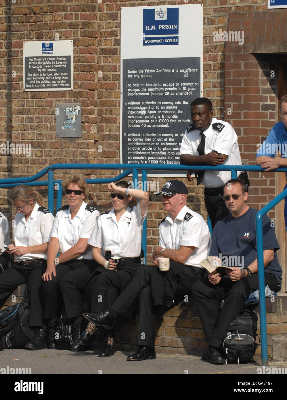 Staff outside at Wormwood Scrubs Prison in London, as thousands of ...