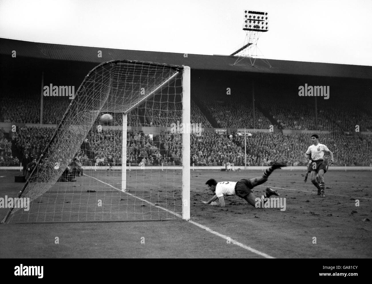 Peter Swan, falling to the ground and Mike McNeil watch as the ball ...