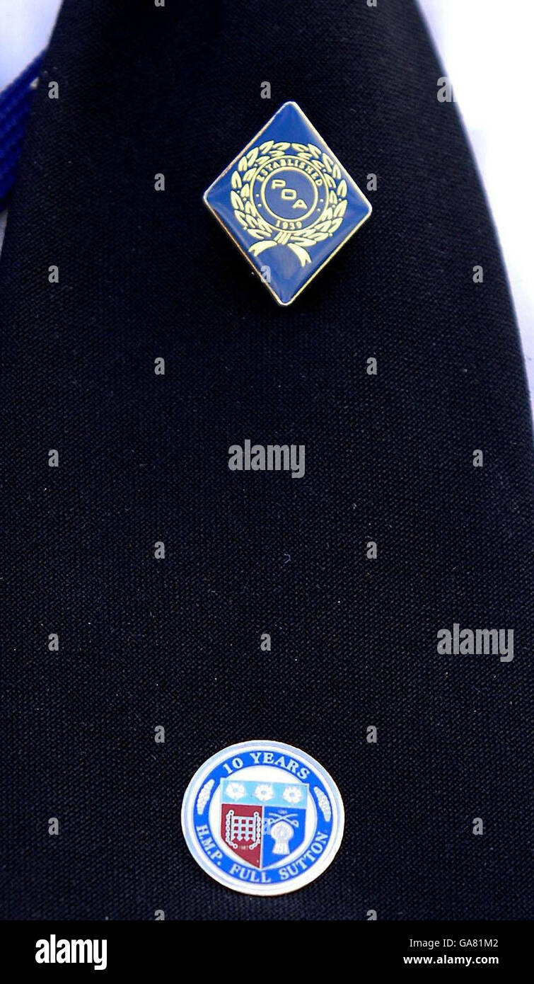 A Prison Officer wearing the POA and a ten year service badge stands ...