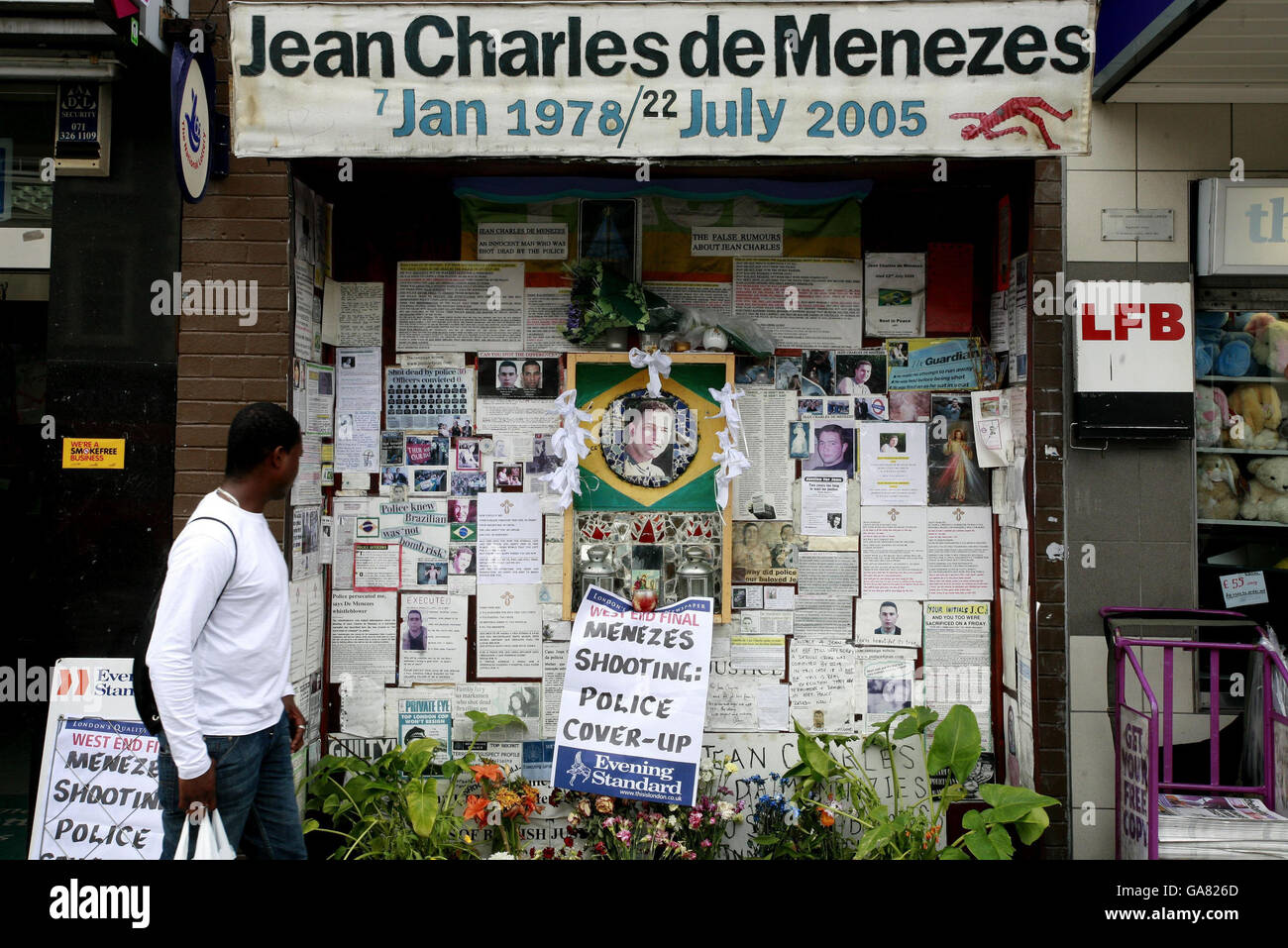 People stop to view the Charles de Menezes memorial in Stockwell, south ...