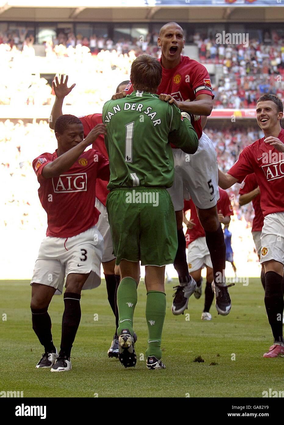 Manchester United goalkeeper Edwin Van der Sar is mobbed by his team ...