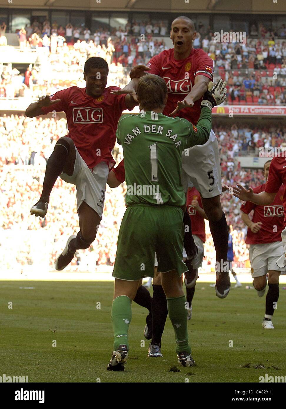 Manchester United goalkeeper Edwin Van der Sar is mobbed by his team ...