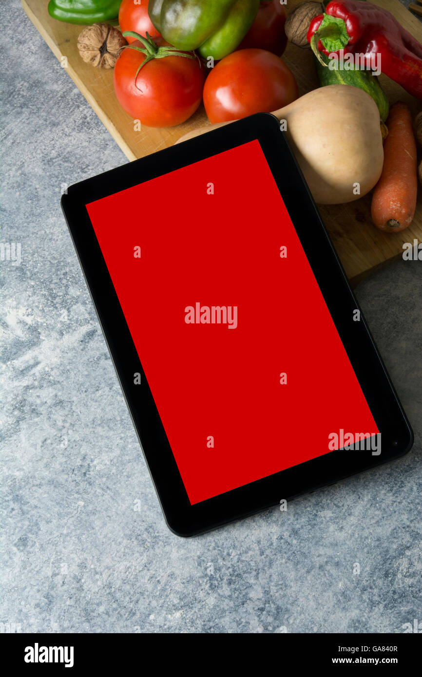 Digital tablet with fresh vegetables on white background Stock Photo ...