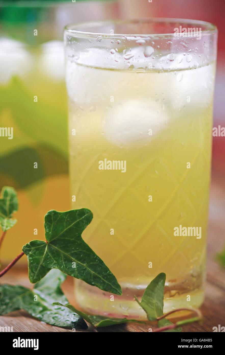 Glass of cold green tea with ice cubes on wooden table Stock Photo - Alamy