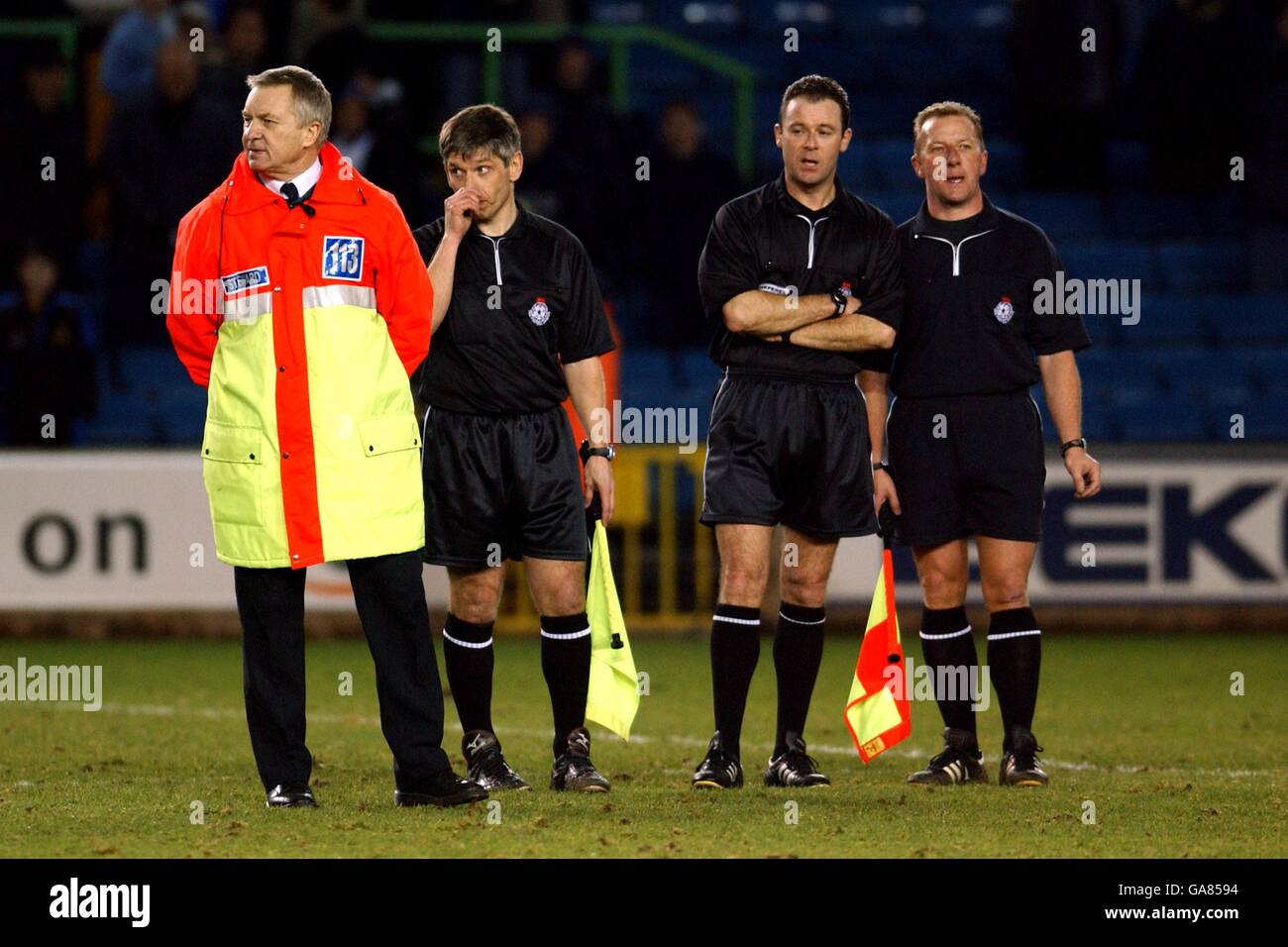 Referee Rob Styles (centre) is guarded by security untill the pitch is ...