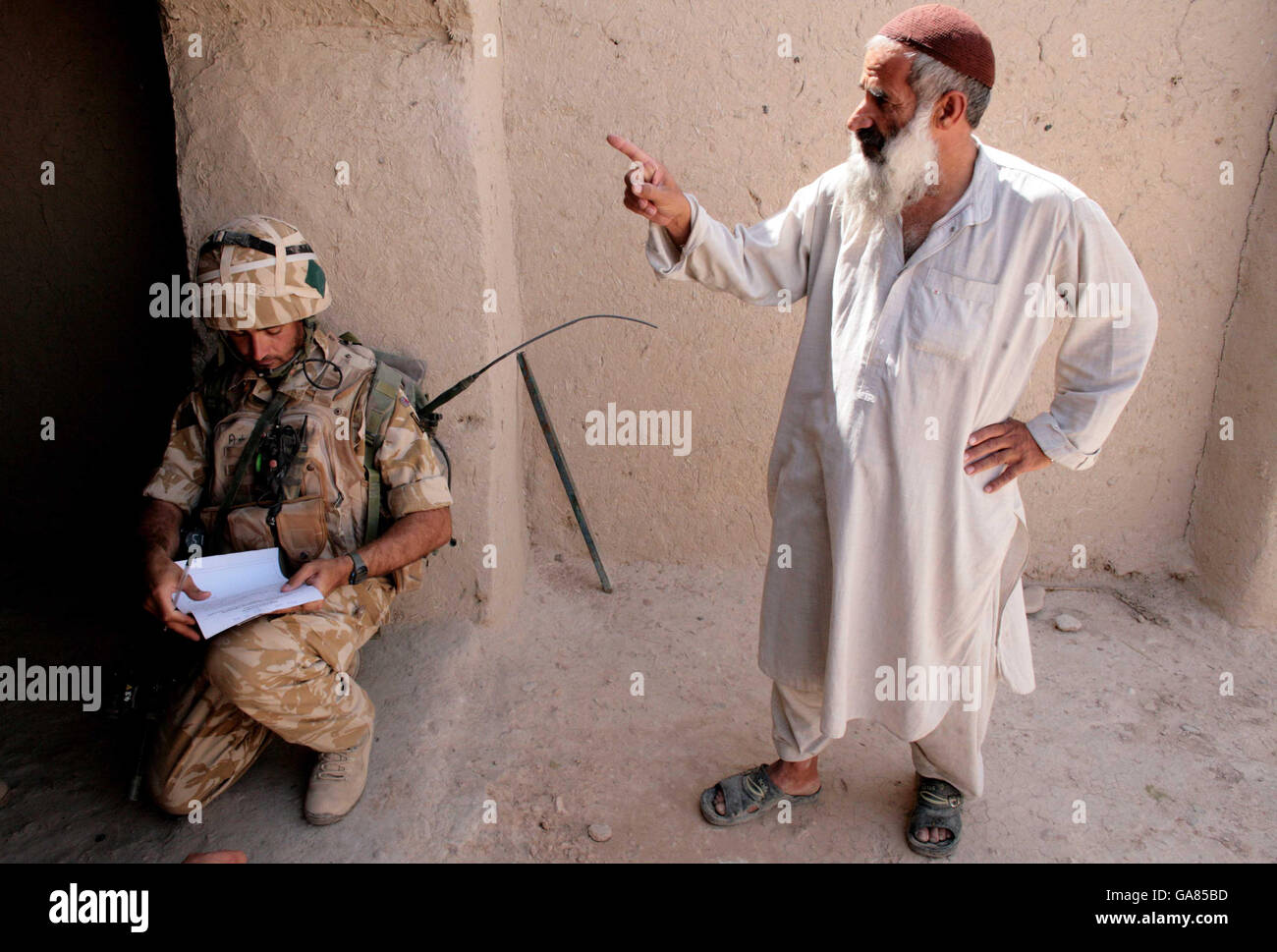 Photo. An Afghan local tells Colour Sargeant Marco Zecca from B company ...