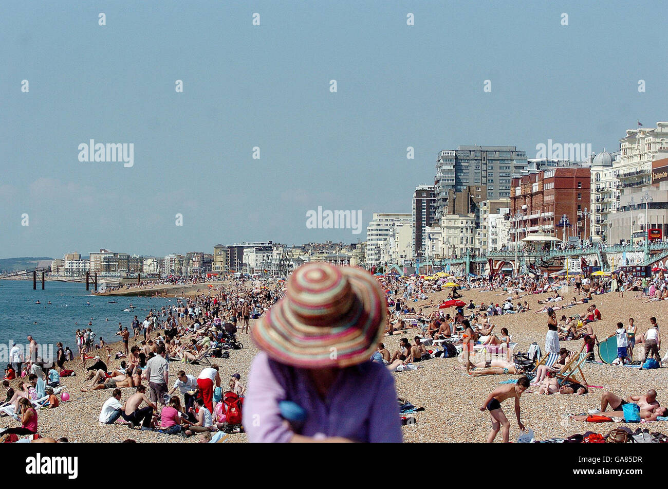 Beachgoers enjoy the sunshine on Brighton beach, Sussex Stock Photo - Alamy