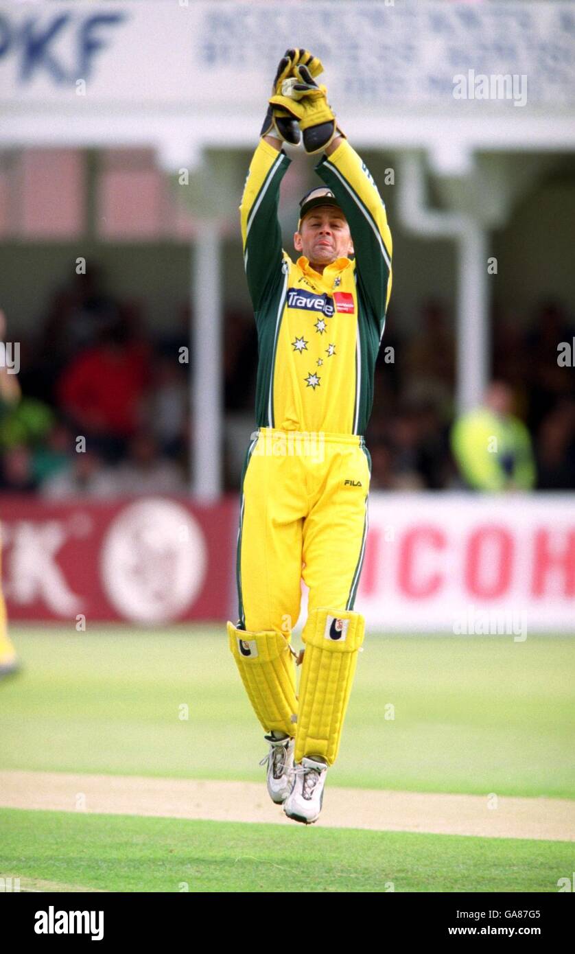 Australian wicketkeeper Adam Gilchrist jumps to catch a ball Stock ...